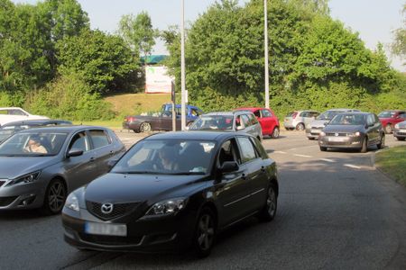 A photo of cars at a roundabout.